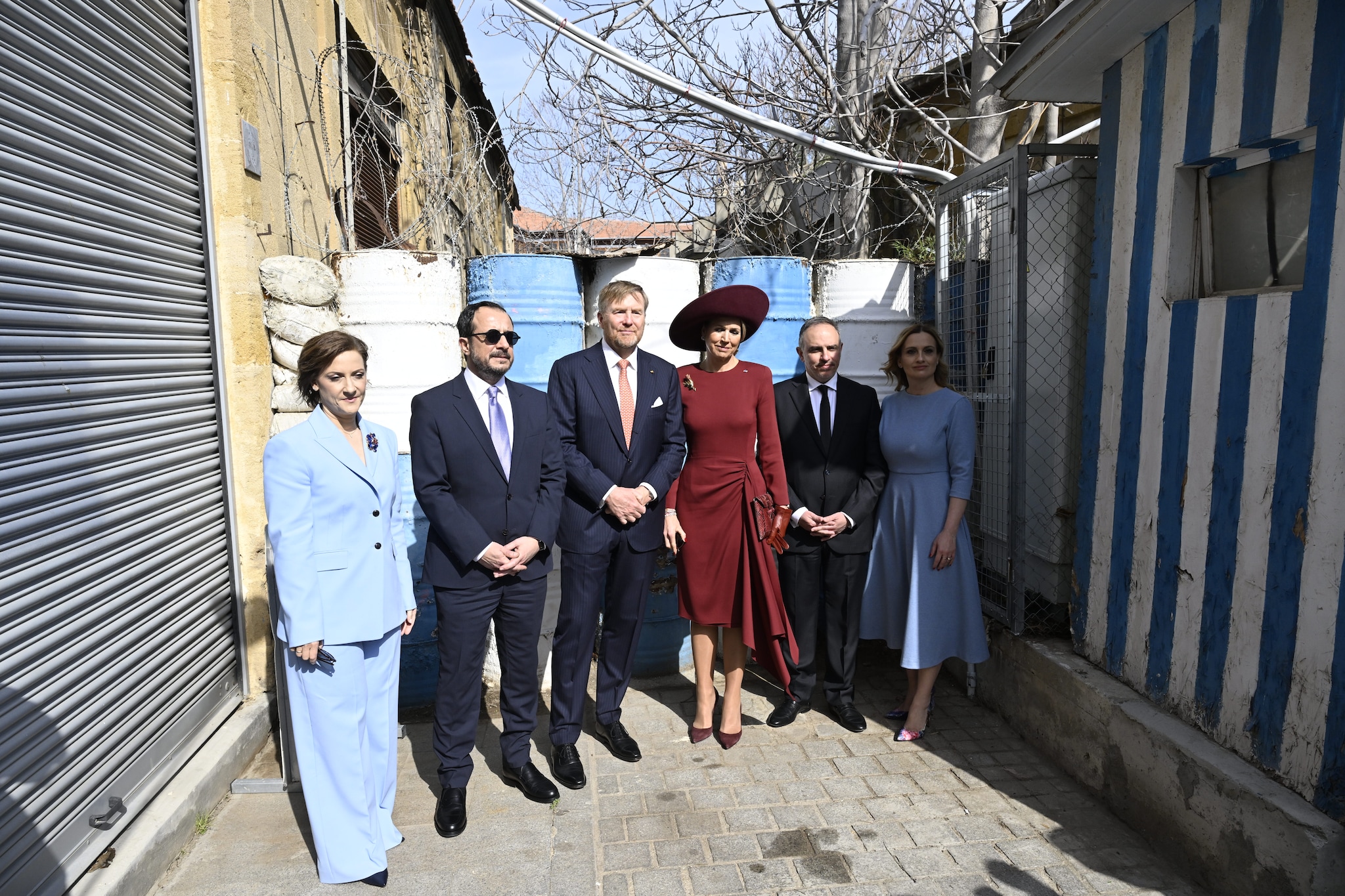Máxima op Cyprus: een rode jurk en broche met een boodschap